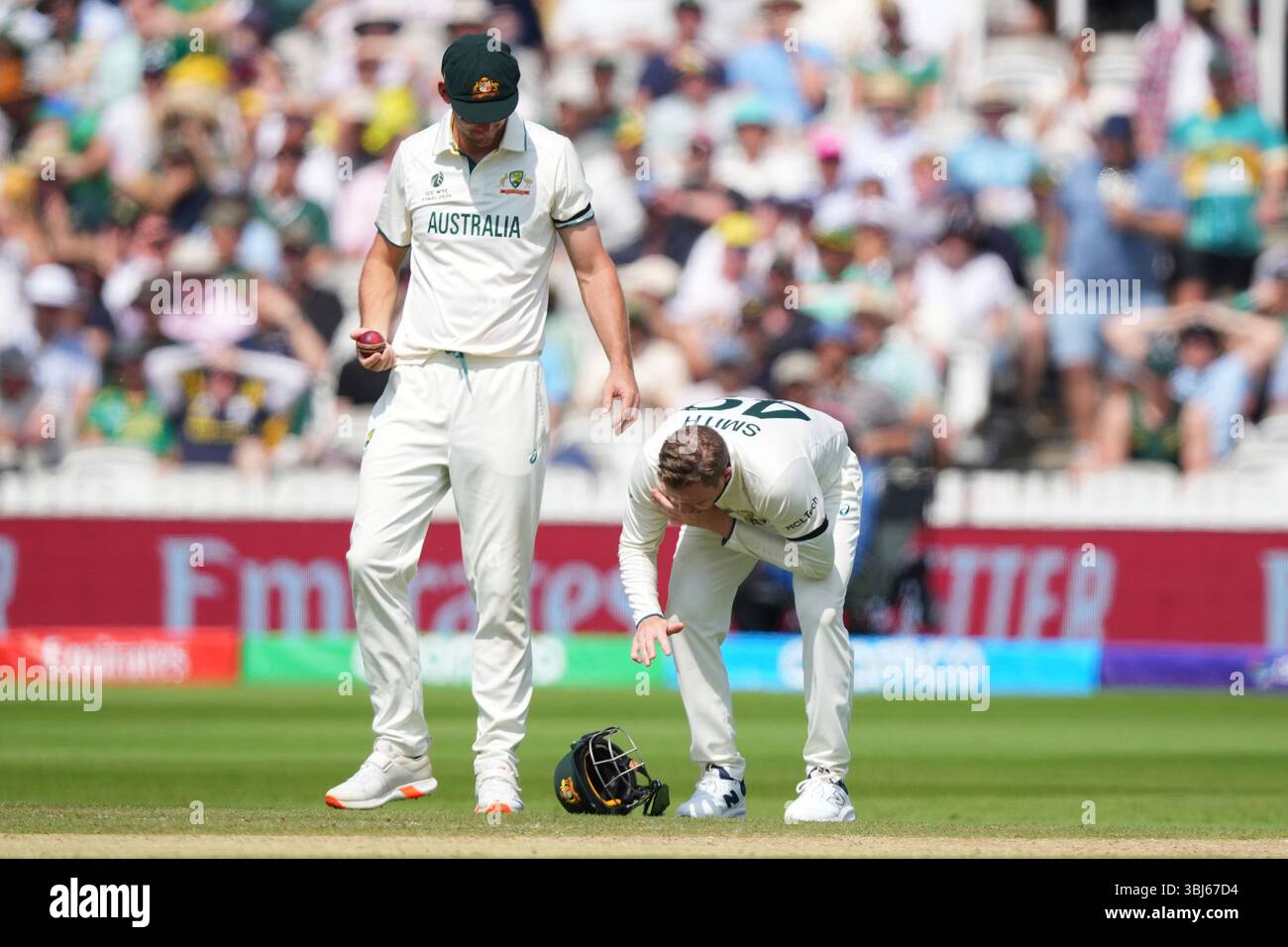 Australia's Steve Smith, right, reacts in pain after getting hurt while ...
