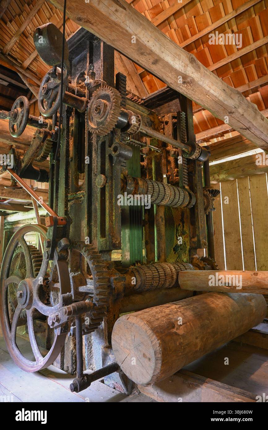 Vintage sawmill equipment processing timber log, showcasing industrial ...