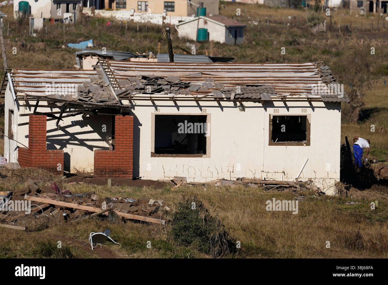 A man salvages belongings from his flood-damaged house in Mthatha ...
