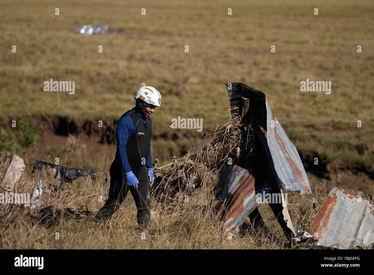A police rescue officer searches for missing people of this week's ...