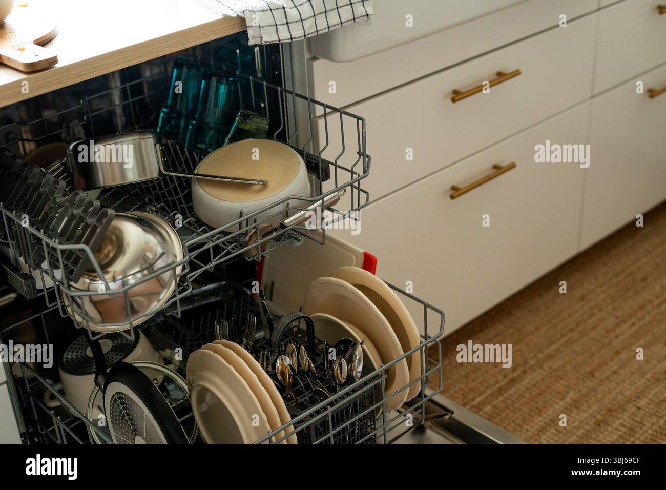 Open dishwasher with various plates Stock Photo - Alamy