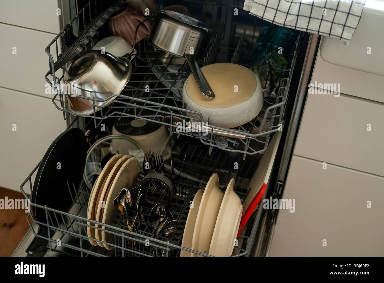Open dishwasher with various plates Stock Photo - Alamy