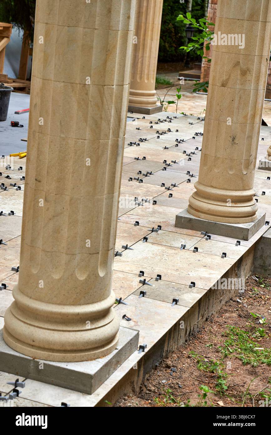 Step-by-step process of laying outdoor paving tiles on a summer veranda ...