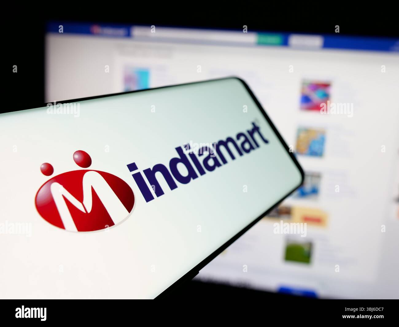 In this photo illustration, a smartphone with the logo of Indian company IndiaMART InterMESH Ltd ...
