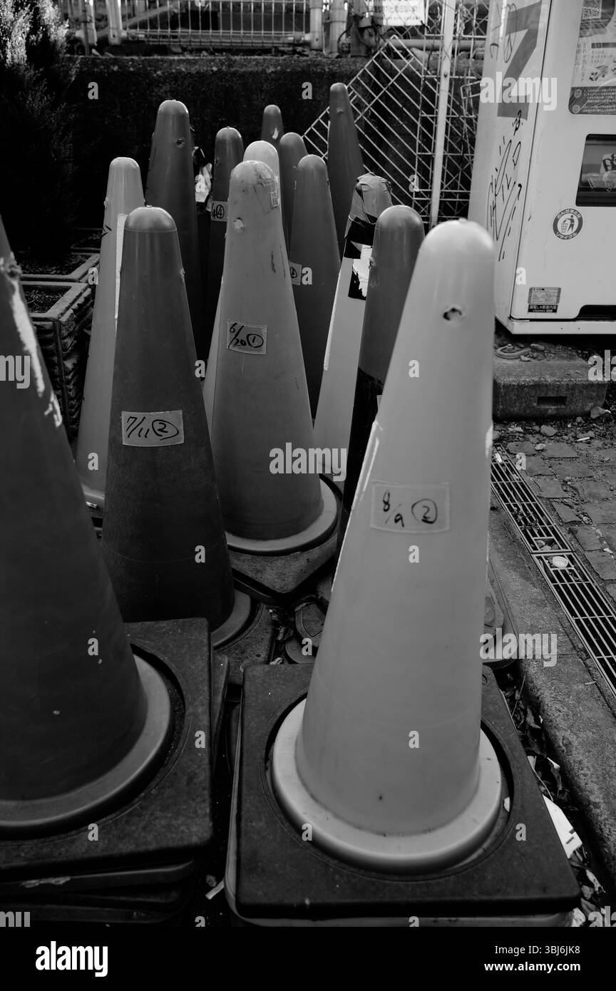 Cluster of numbered traffic cones in a Tokyo alley—each marked ...