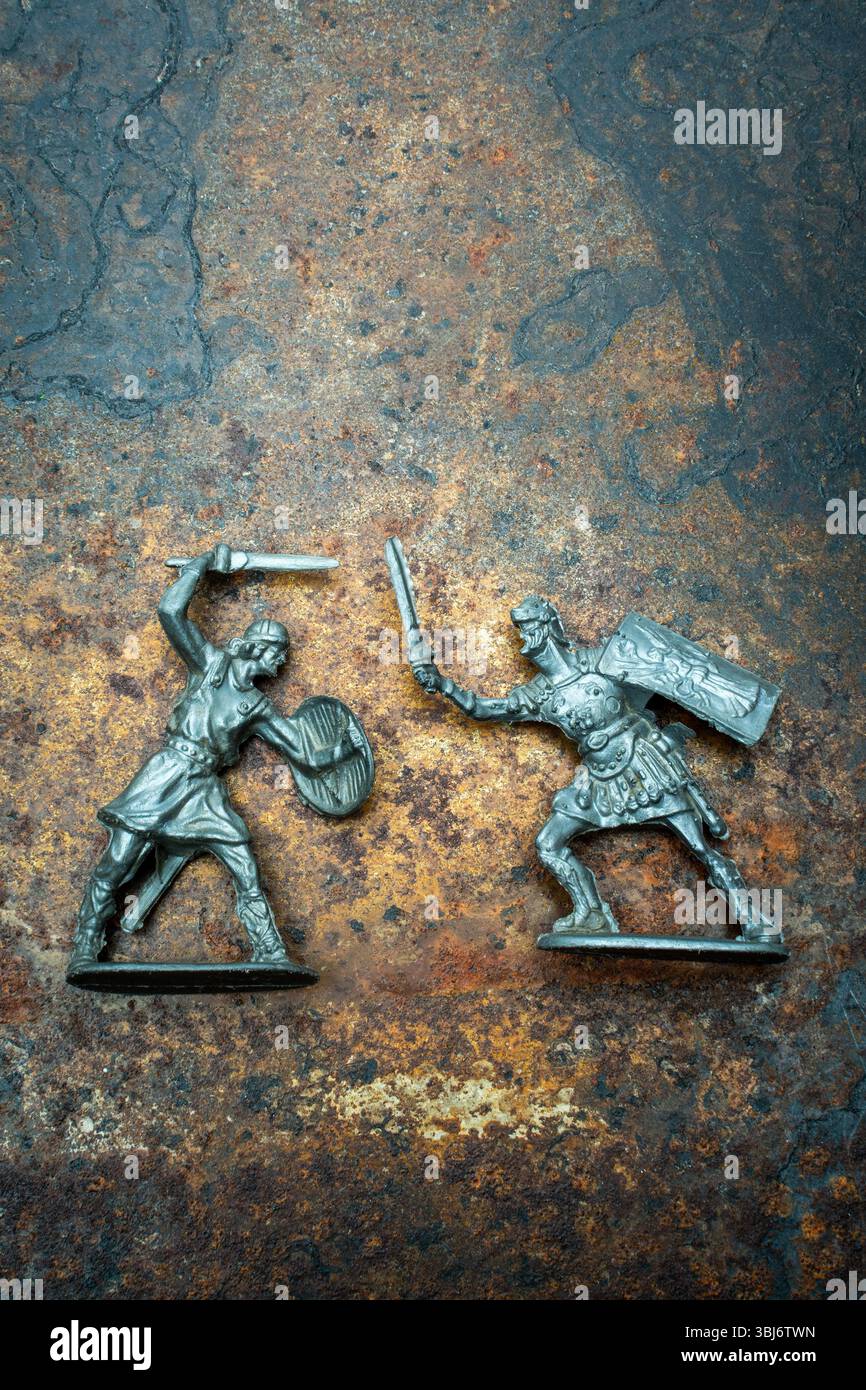 Two plast miniature figures depict a warrior with a shield and sword ...