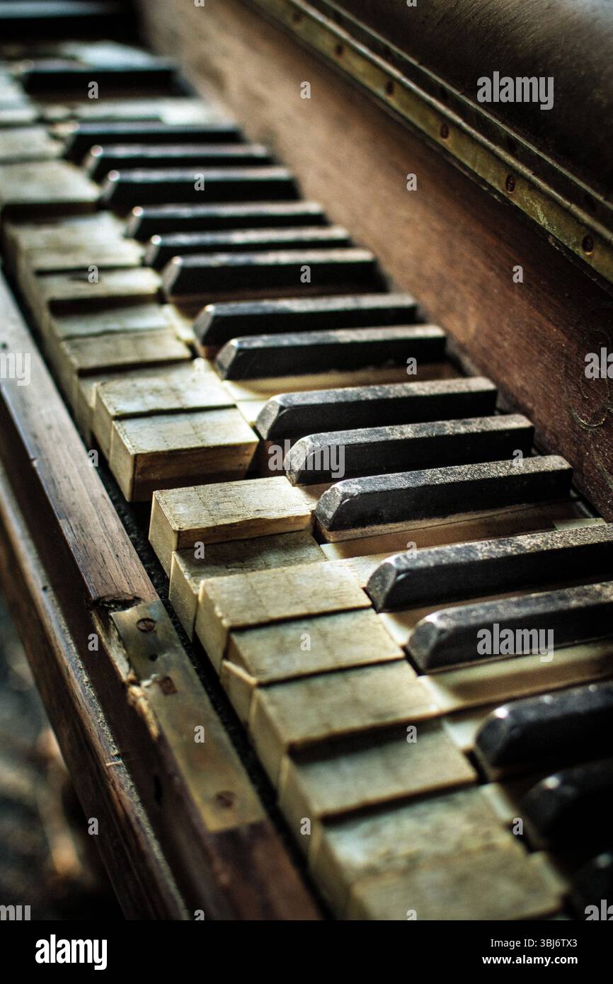 Focus on worn piano keys reveals the beauty of music and memories. The ...