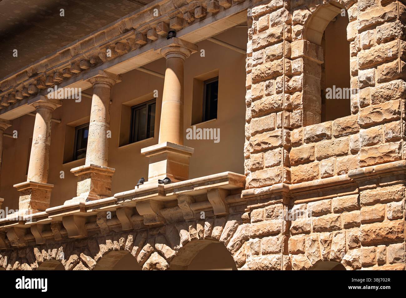 Part of a historic Mediterranean building facade with stone arches ...