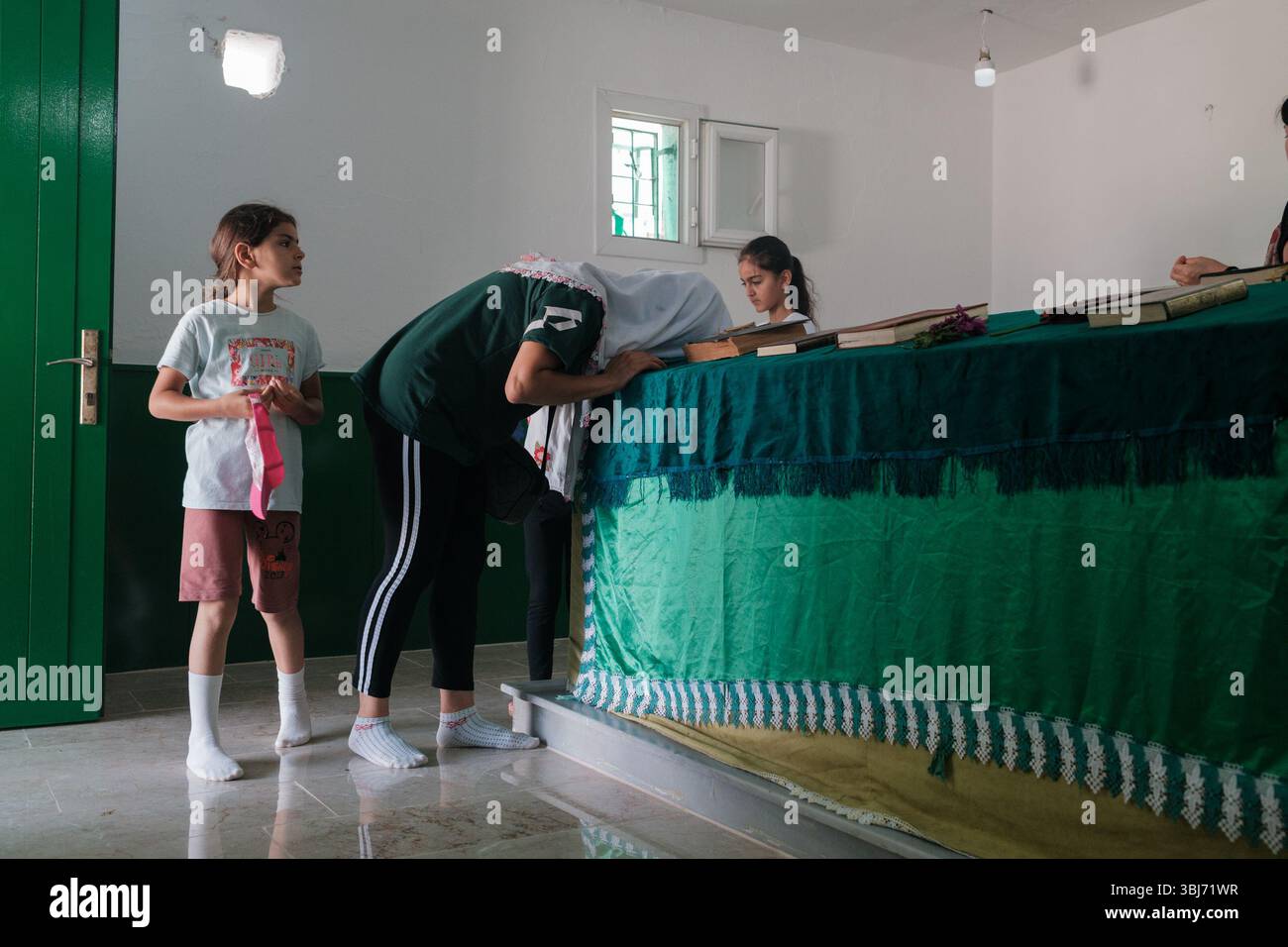 June 23, 2024, Hatay, Turkey: A woman kissing the grave of an Arab ...