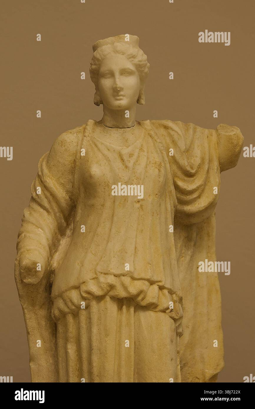 Marble statue of an ancient woman in classical dress, on display in a ...