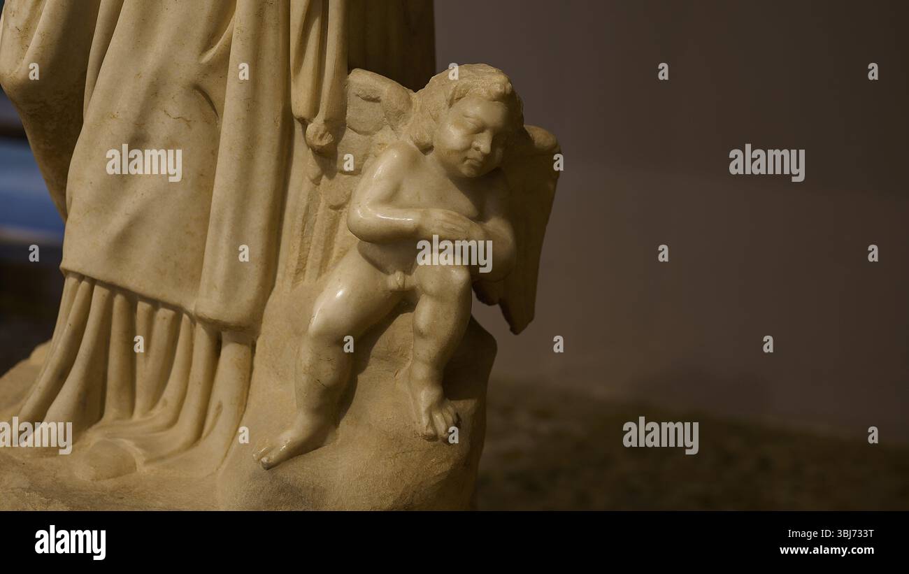 Marble sculpture of a small angel as part of a larger statue, carved in ...