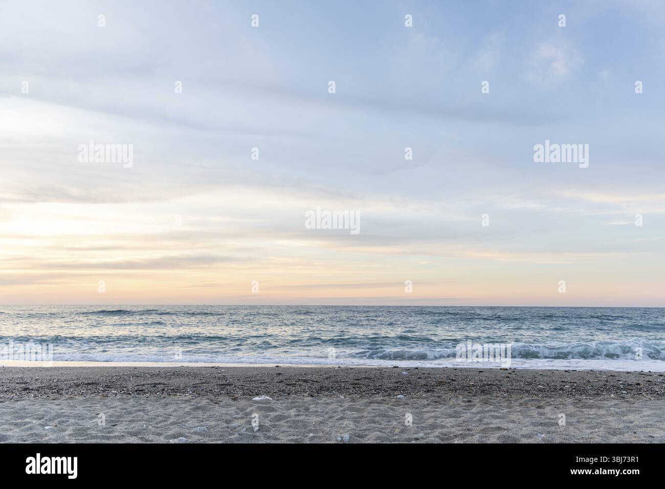 Beautiful coastline with a sandy beach and pebble beach at sunset ...