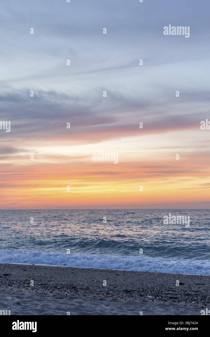 Beautiful coastline with a sandy beach and pebble beach at sunset ...