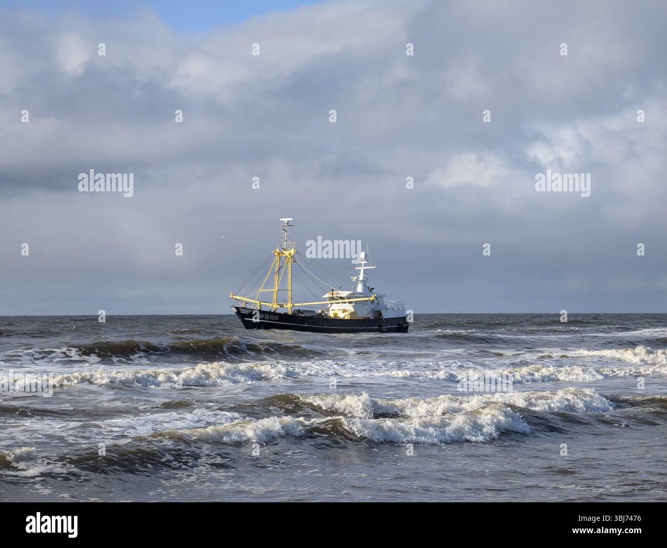 Fishing trawler battling the waves in high seas, Texel, North Holland ...
