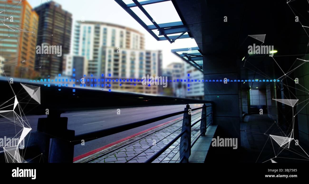 Framing metal railing lining sidewalk beside road under glass canopy ...