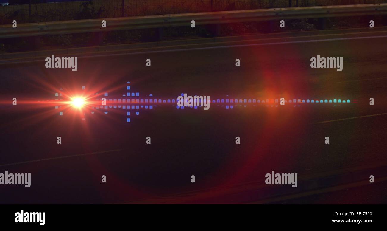 Vehicle headlight producing lens flare with colored reflections on road ...