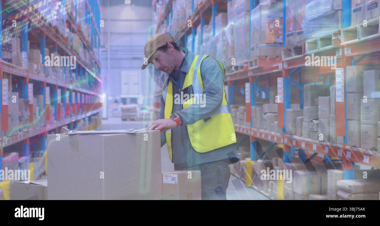 Worker wearing yellow safety vest checking boxes on pallet in warehouse ...