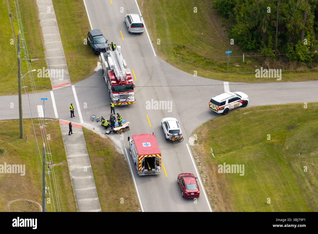 First responders at car hit cyclist accident site in Florida. Victim on ...