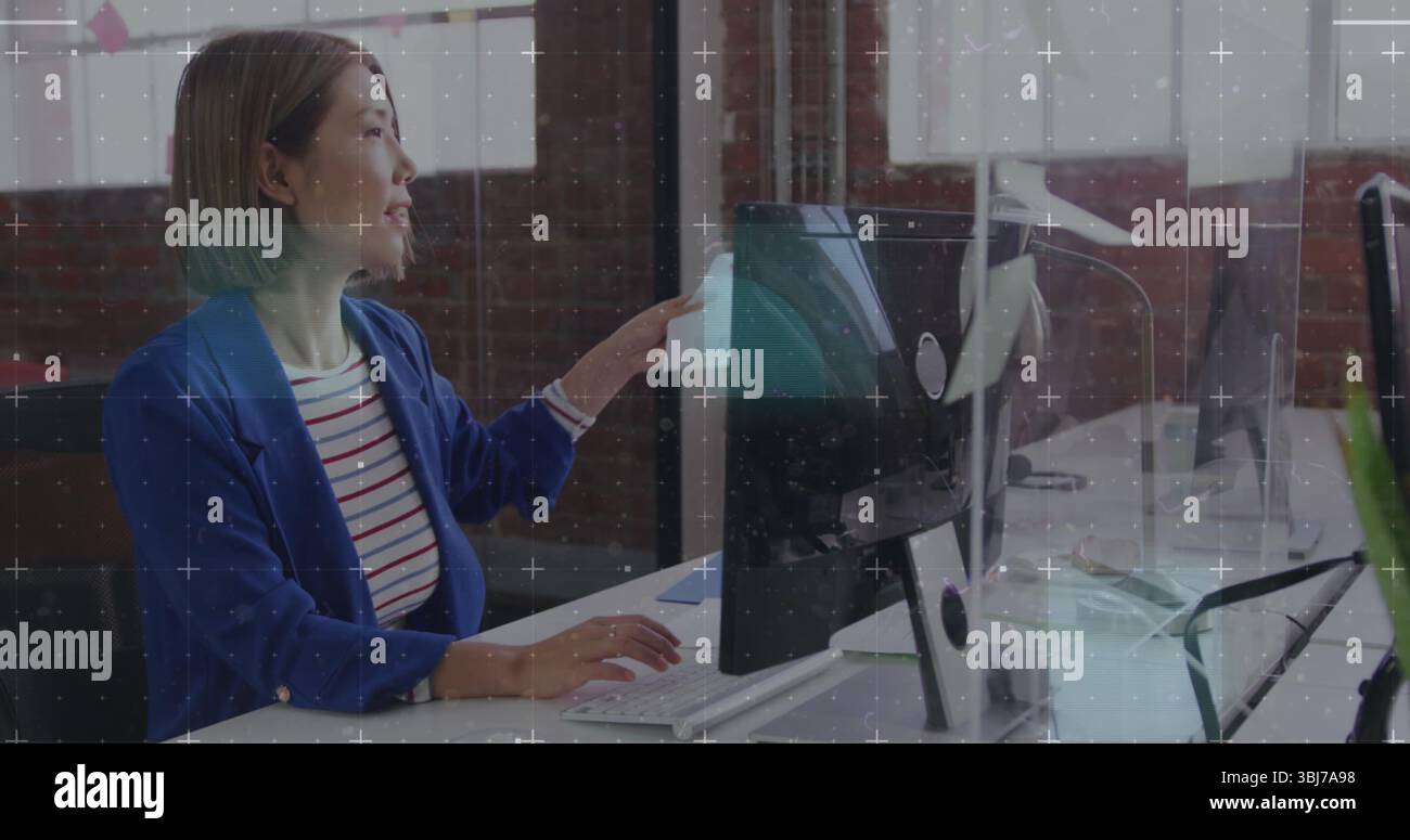 Woman seated desk typing monitors hi-res stock photography and images ...