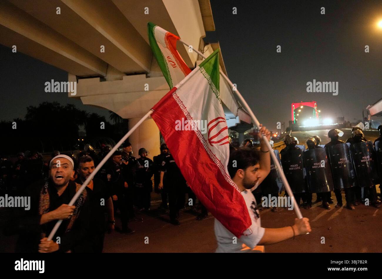 Protesters carry Iranian flags during a protest against Israeli attacks ...
