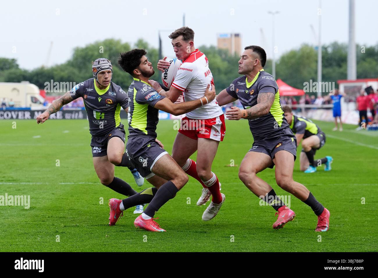 Hull KR's Jack Broadbent (centre) is tackled by Catalans Dragons ...
