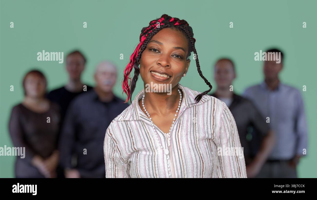 Confident Black female executive with braids standing in front of ...