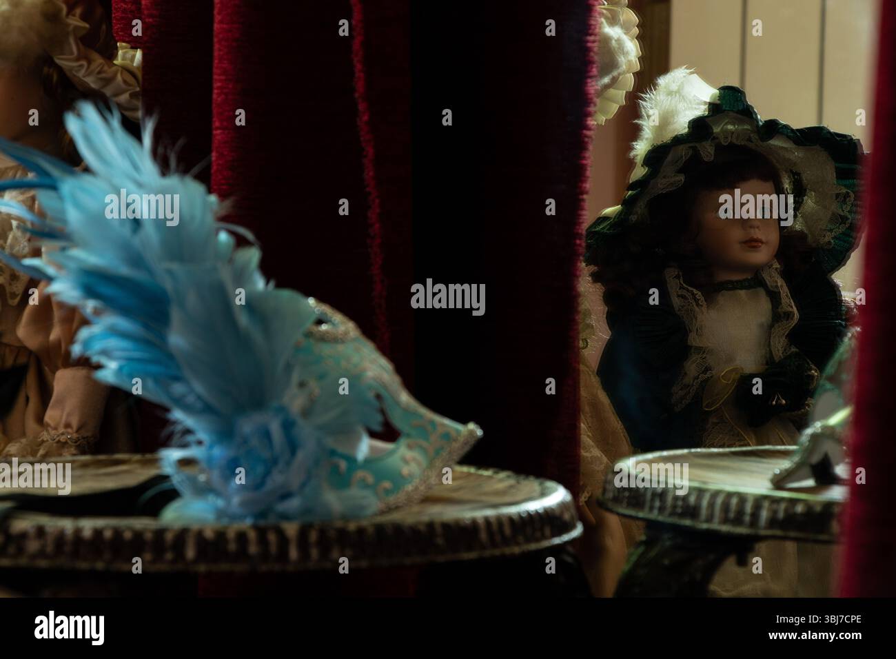Carnival mask lies on a chair and in the reflection of a mirror doll ...