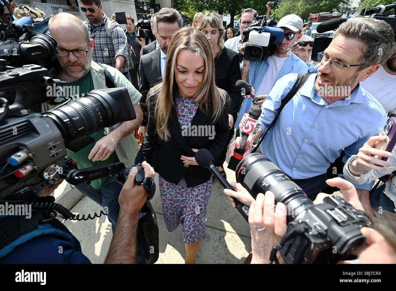 Karen Read, is surrounded by reporters as she and her legal team leave ...
