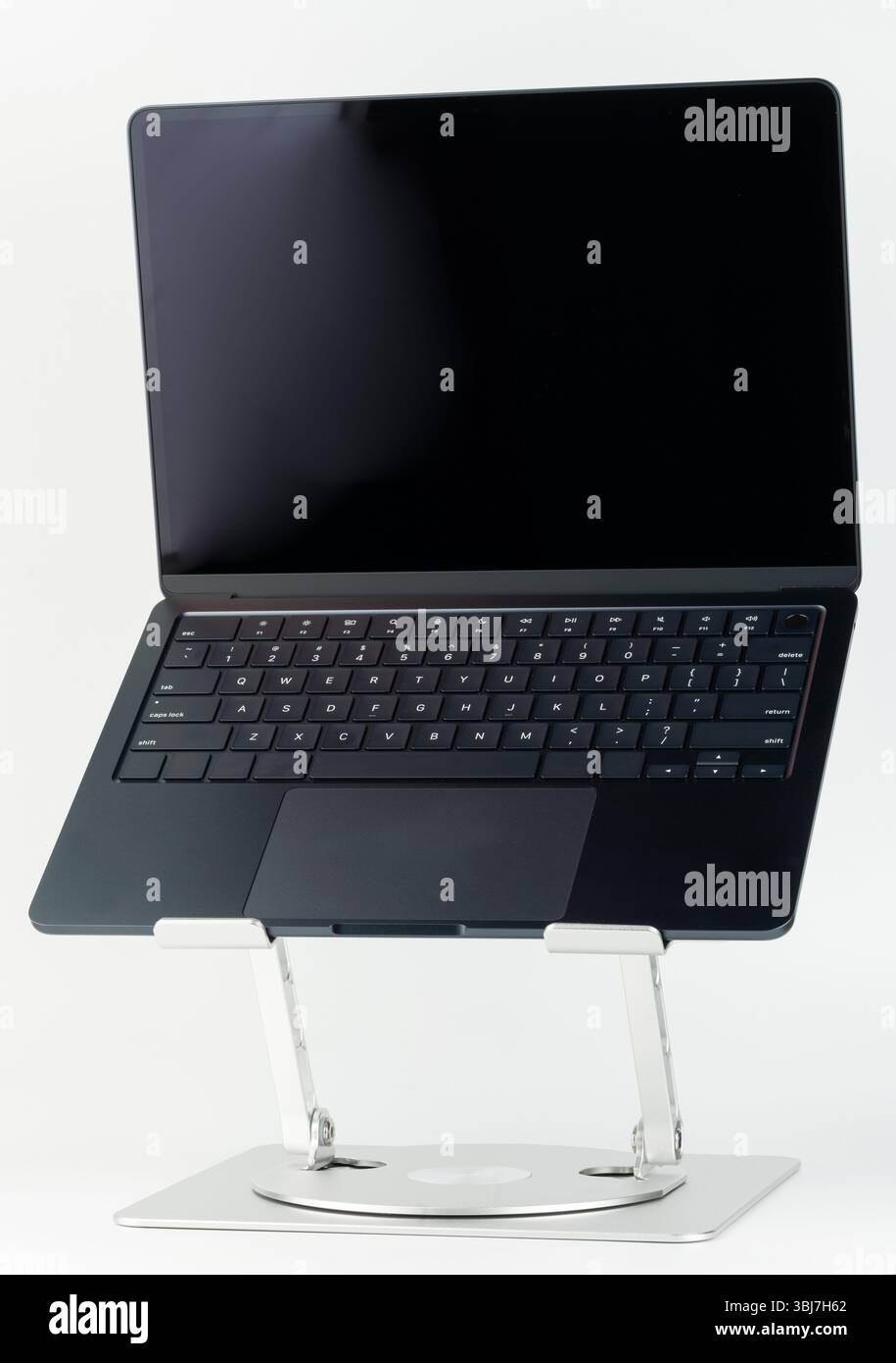 mMinimalistic laptop positioned on stylish stand, emphasizing its sleek ...