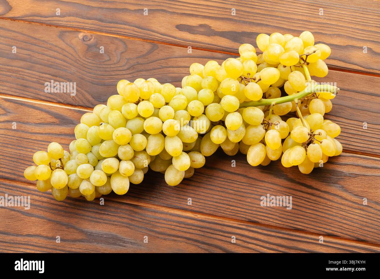 sultana seedless grape on brown wood background Stock Photo - Alamy