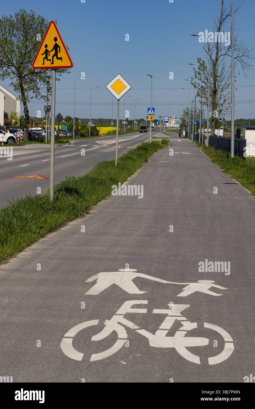 Pedestrian and bicycle path along suburban road with clear safety ...