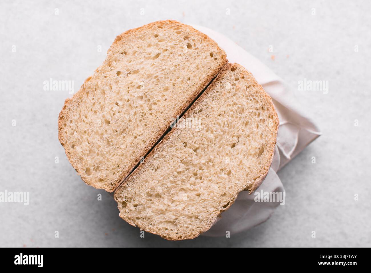 Overhead view of sliced homemade artisan bread on marble countertop ...