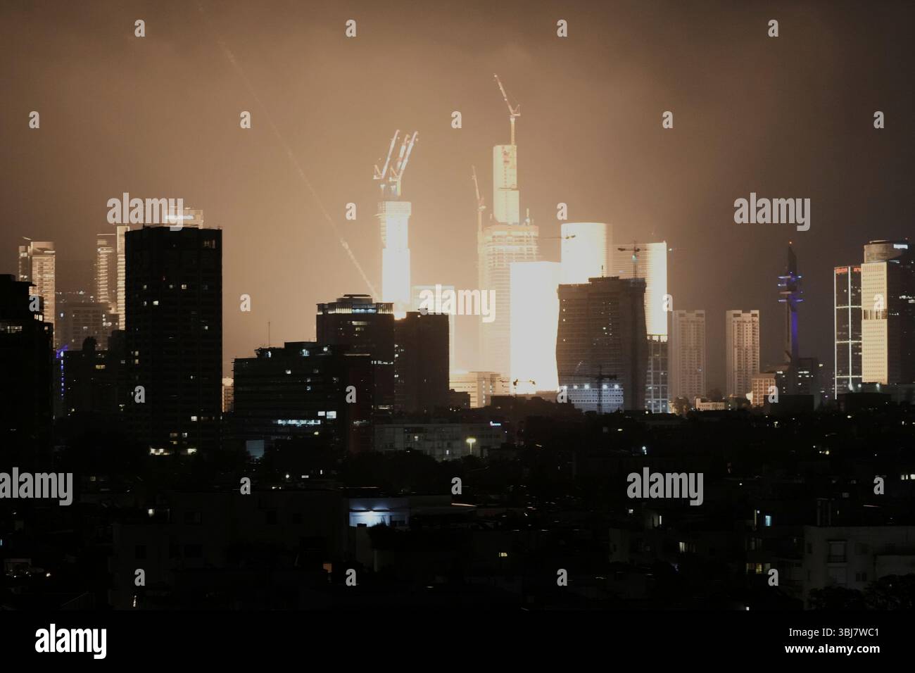 An explosion caused by a projectile strike illuminates the skyline in ...