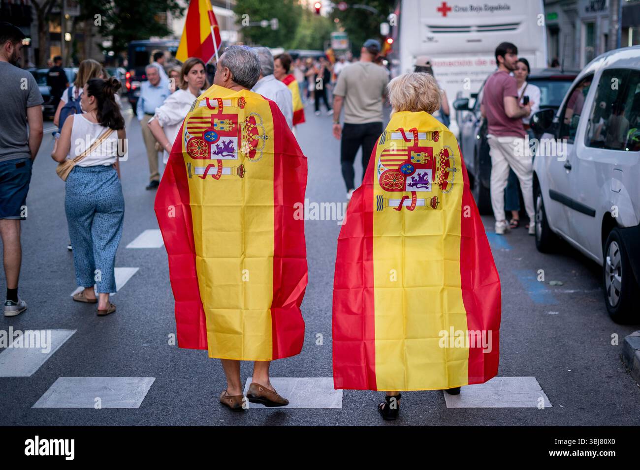 Two people wearing the Spanish flag during the Demonstration against ...