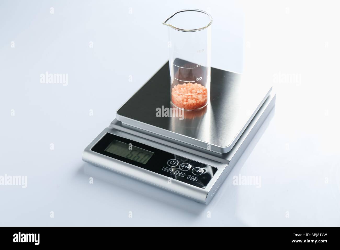 Laboratory scale with beaker of sample on white background Stock Photo ...