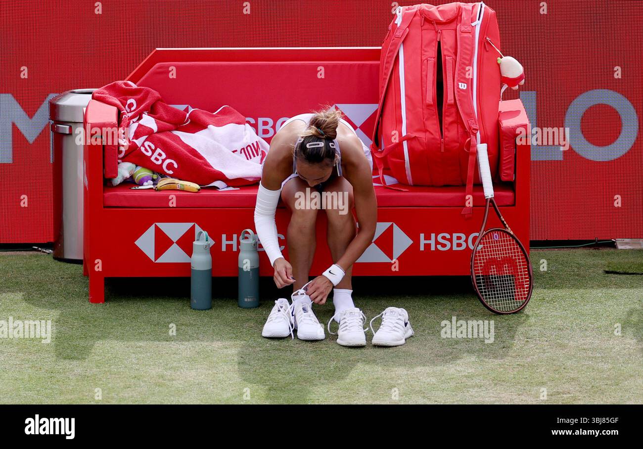 London, Britain. 13th June, 2025. Zheng Qinwen changes shoes during the ...