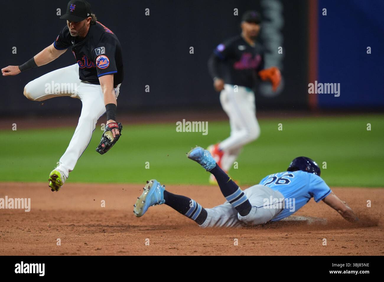 New York Mets' Jeff McNeil, left, leaps over Tampa Bay Rays' Kameron ...