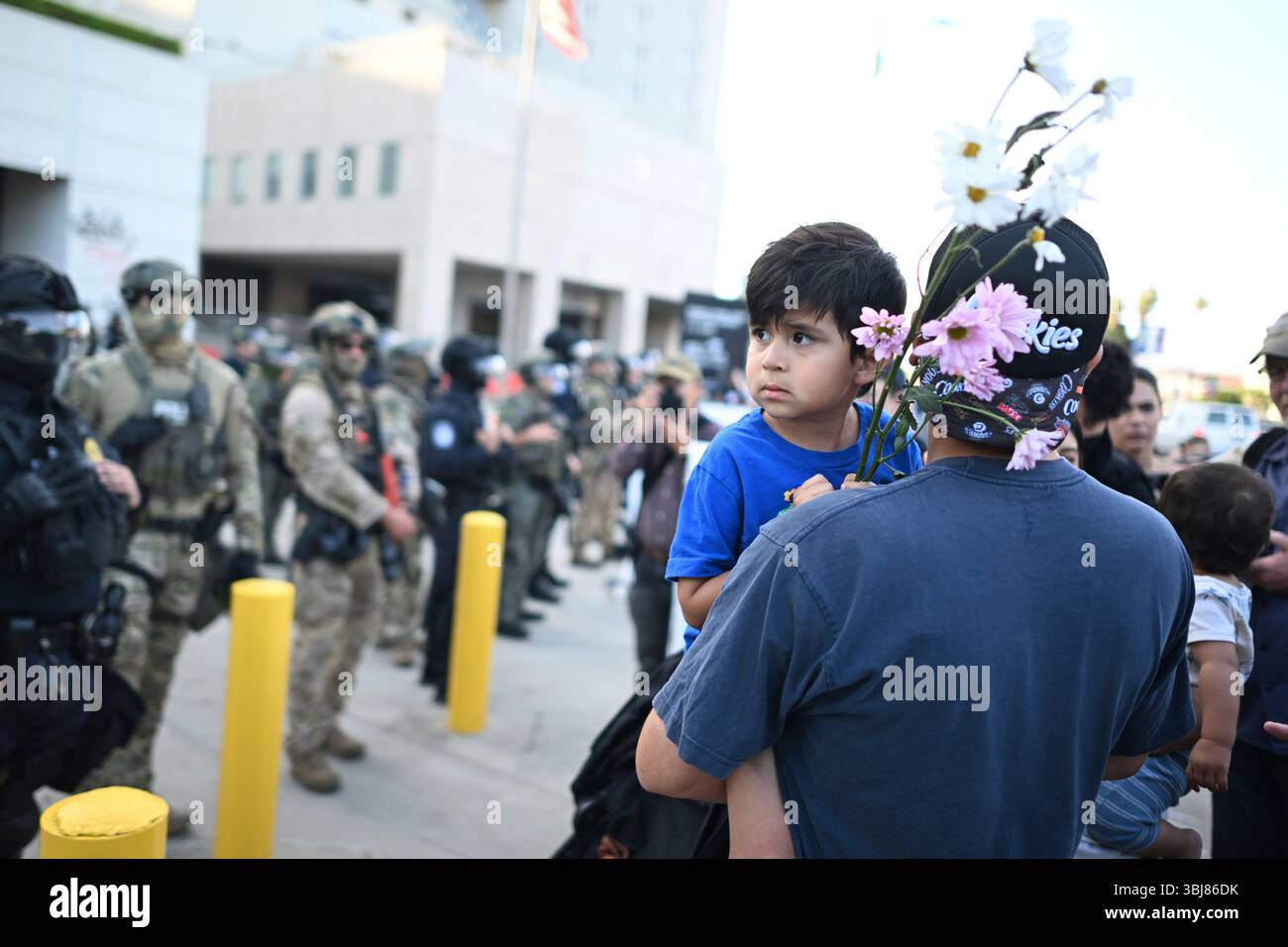 Tony Robles holds his son Malakey during a protest outside the Federal ...