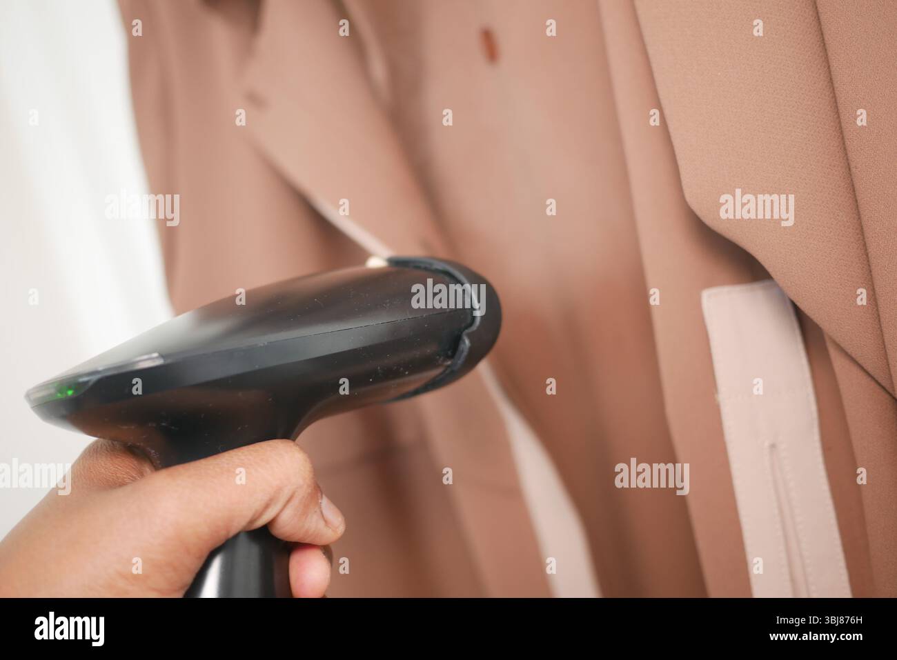 Scanning clothing for retail inventory Stock Photo - Alamy