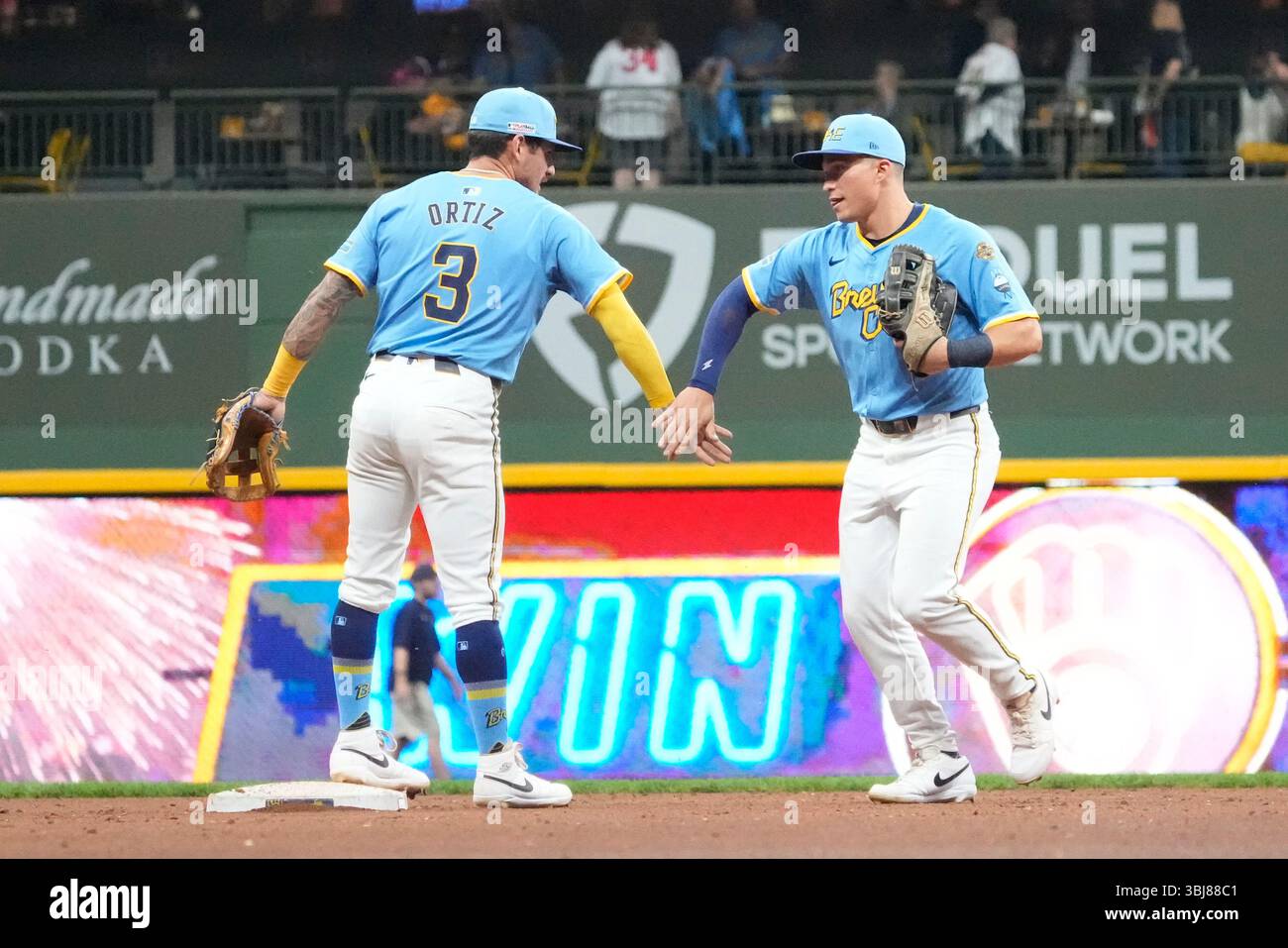 Milwaukee Brewers shortstop Joey Ortiz celebrates with Isaac Collins ...