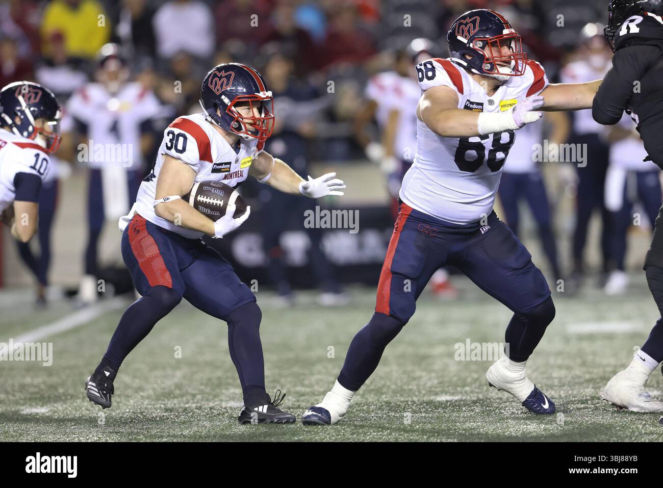 June 13, 2025: Montreal Alouettes Travis Theis (30) runs with the ball ...