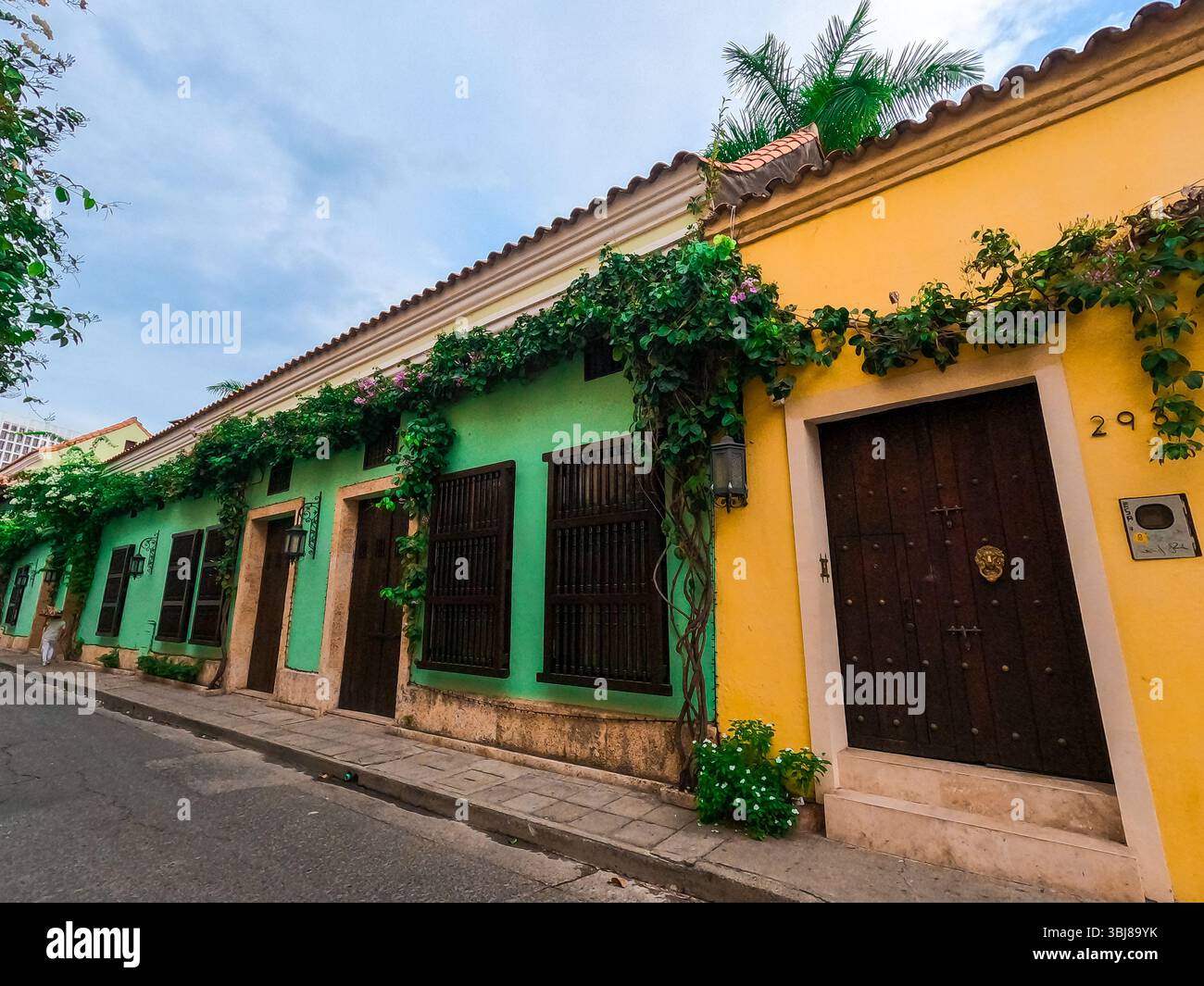Vibrant colonial architecture adorned with greenery, showcasing the charm of Cartagena, Colombia ...