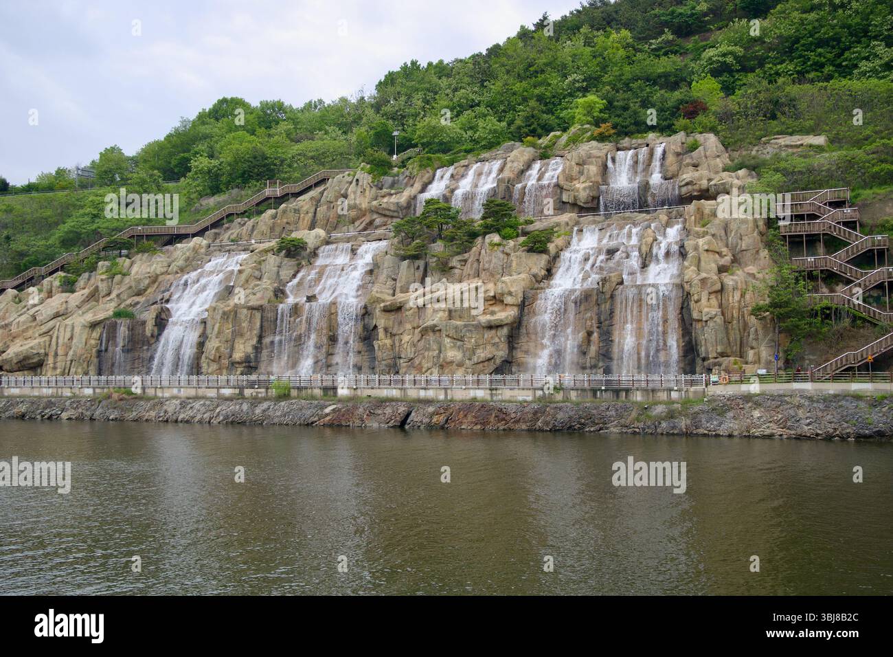 Incheon, South Korea - May 19th 2025: Water rushes down the tiered rock ...
