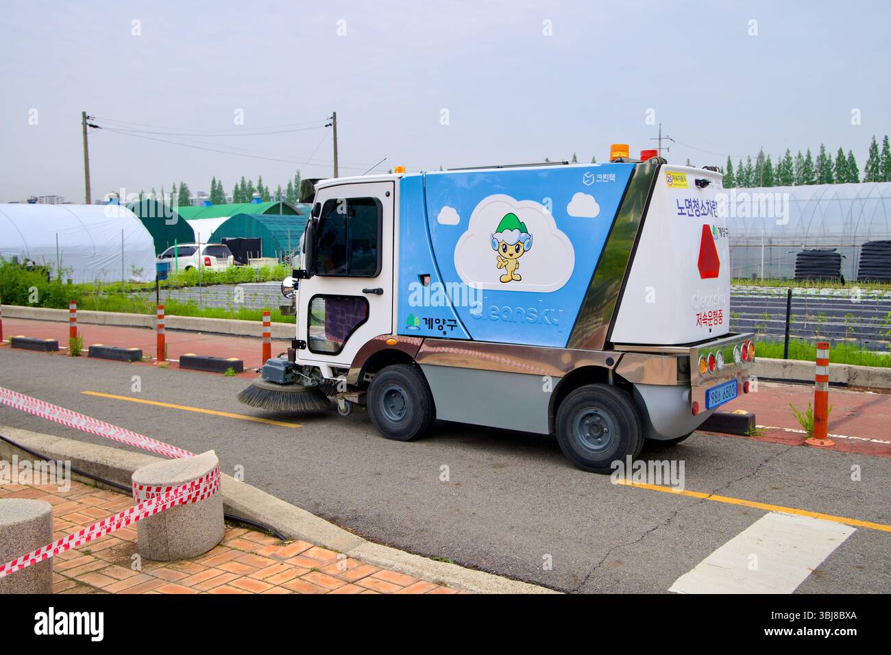 Incheon, South Korea - May 19th 2025: A compact street sweeper marked ...