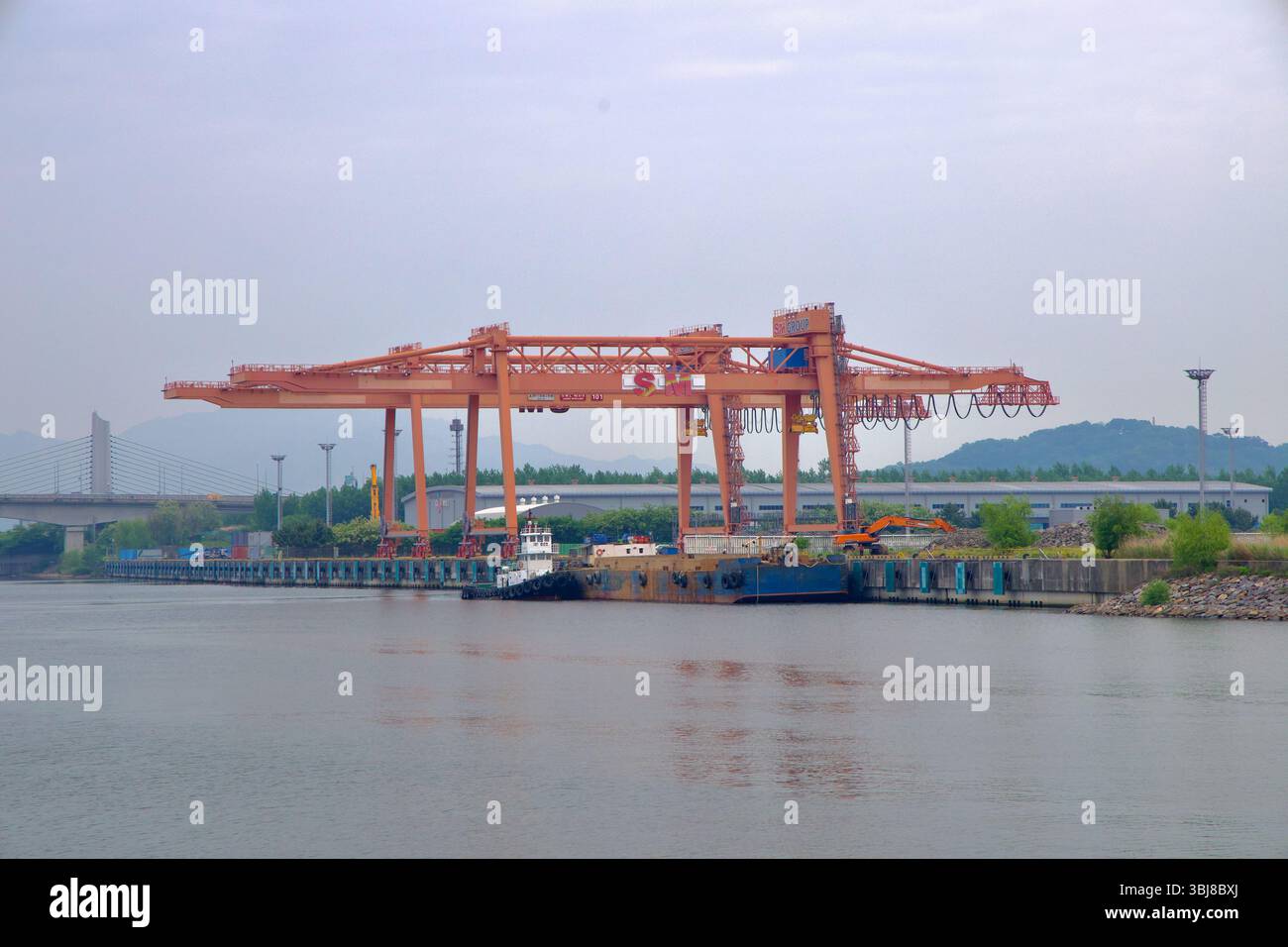 Incheon, South Korea - May 19th 2025: Massive orange cranes operated by ...