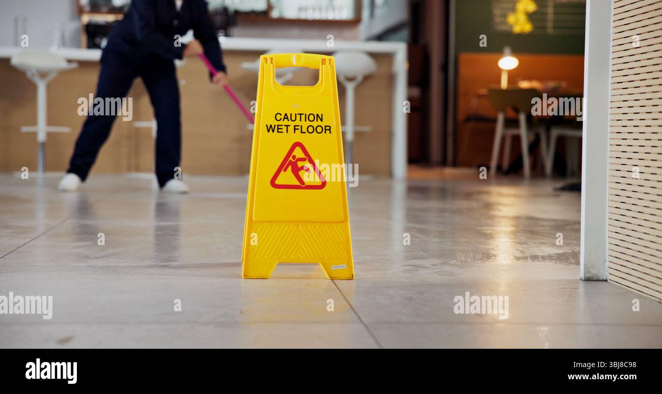 Cleaning, business and caution for wet floor, warning and person with ...