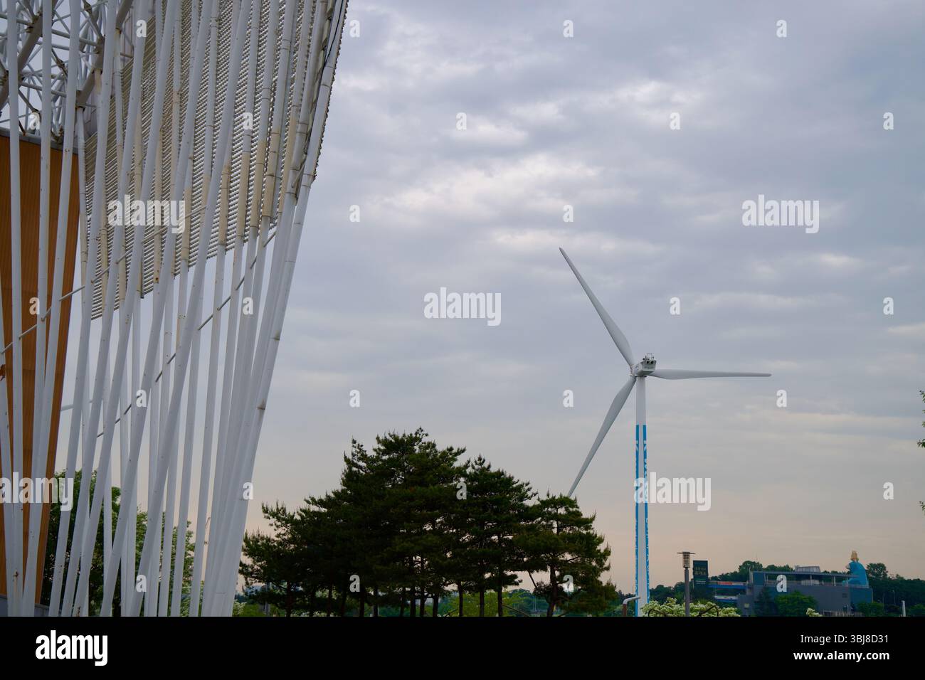 Incheon, South Korea - May 19th 2025: A wind turbine spins beside the ...