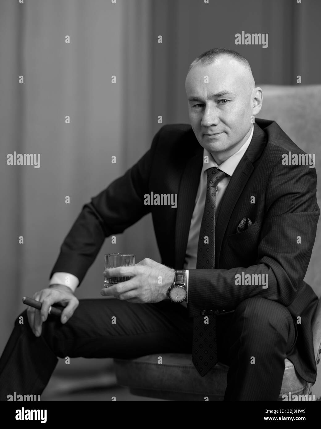 Rich man tasting cognac in Black and White Stock Photos & Images - Alamy