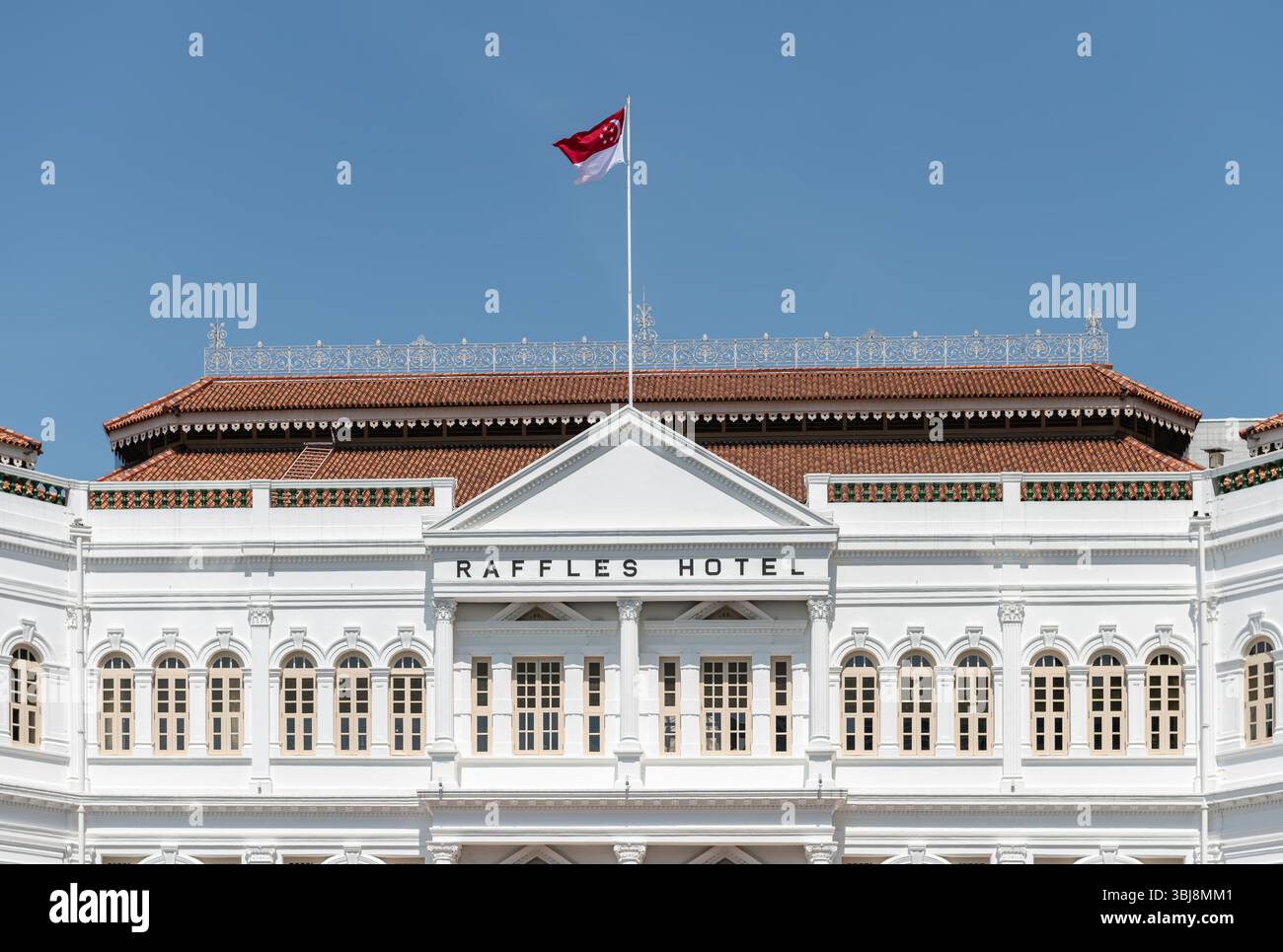 Singapore flag flying over The Raffles Hotel on Beach Road, Singapore ...
