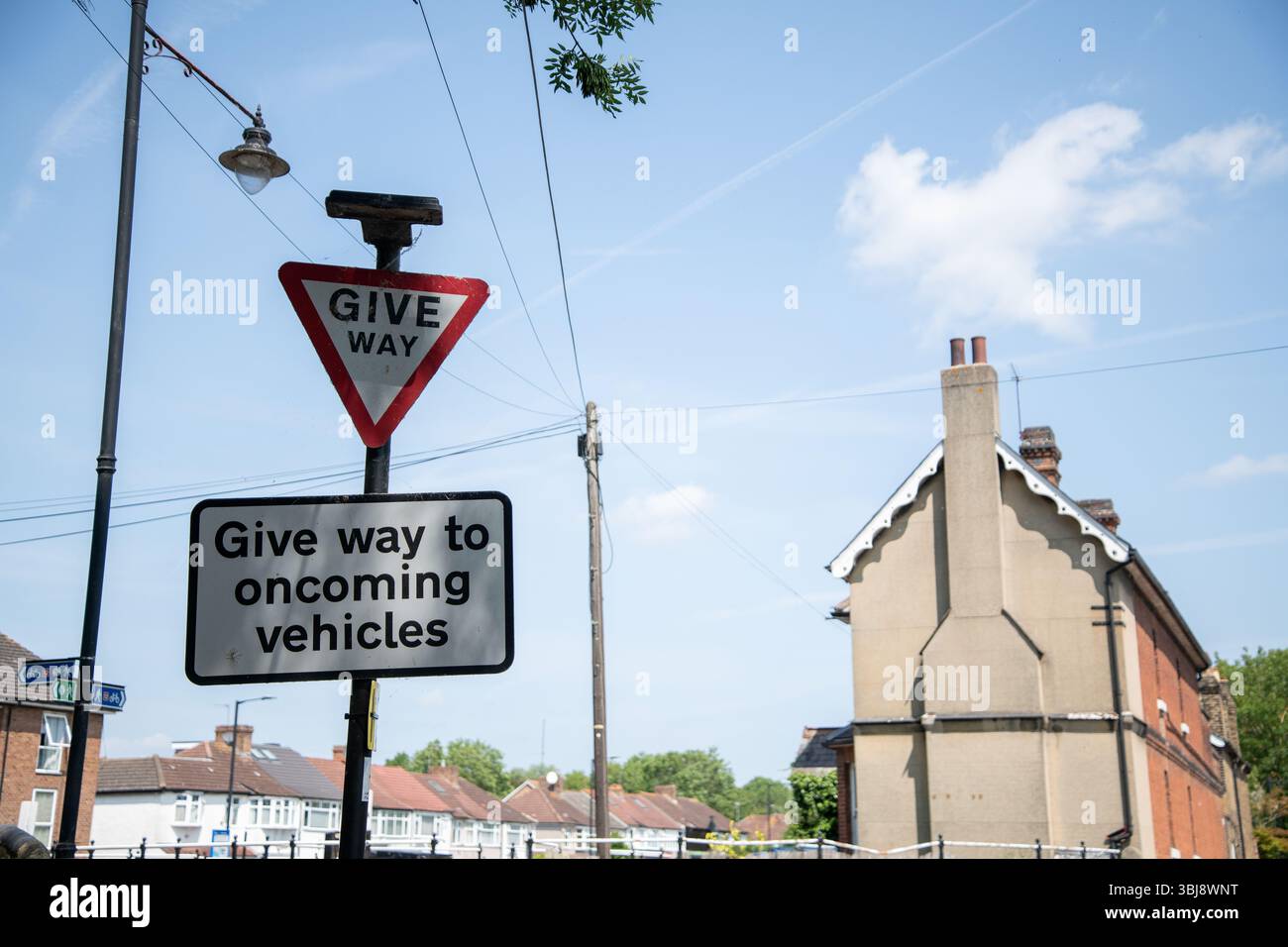 UK road sign with a triangular "Give Way" warning above a "Give way to ...